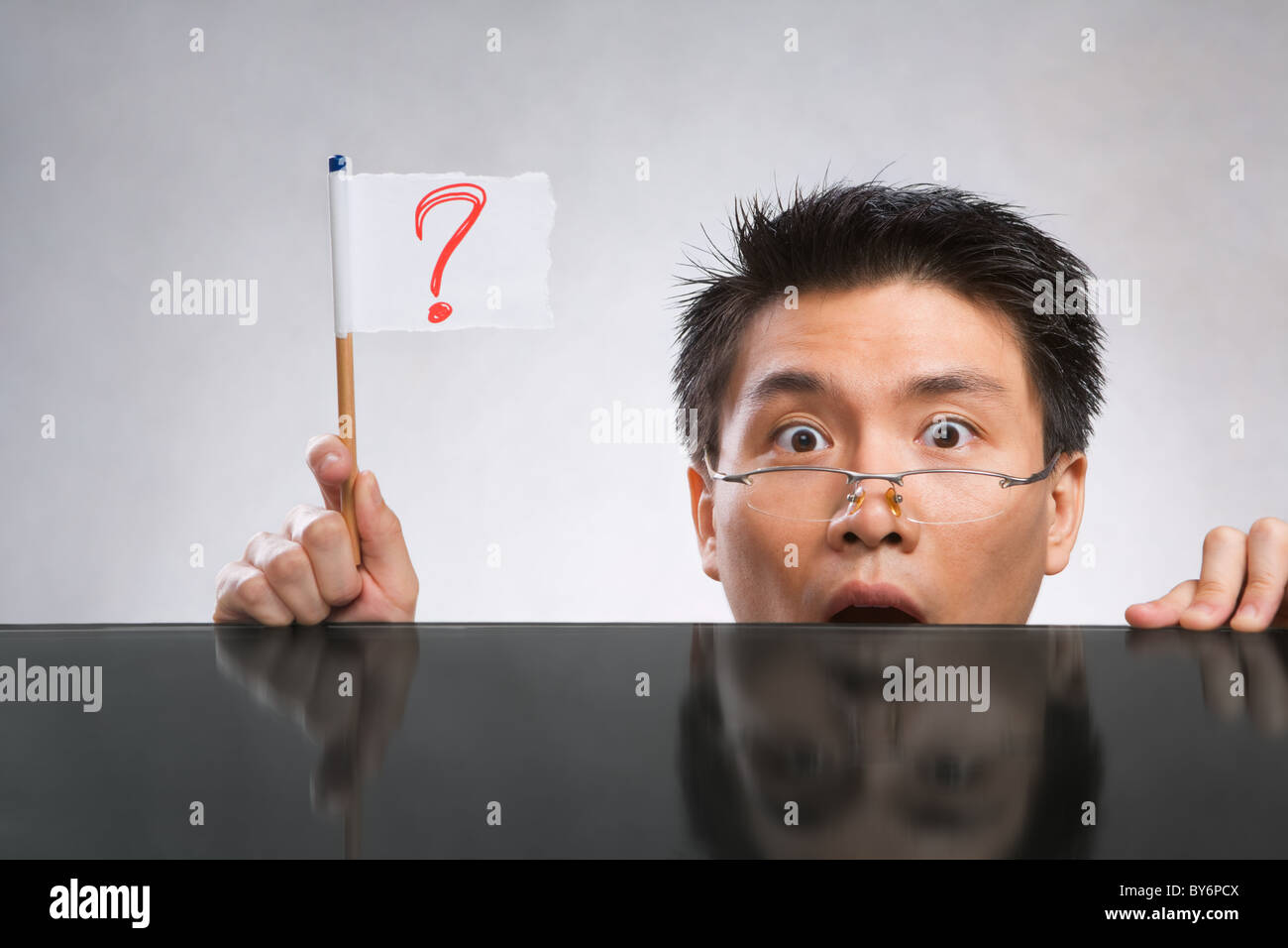 Man holding question mark flag made of paper and pencil Stock Photo - Alamy
