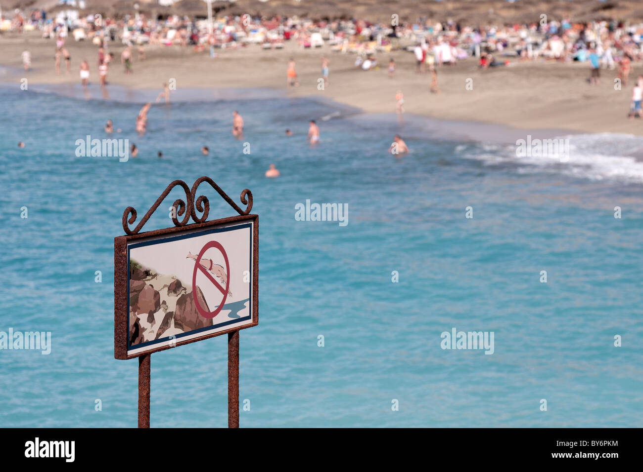 Warning sign prohibiting diving from the rocks into the sea on the ...