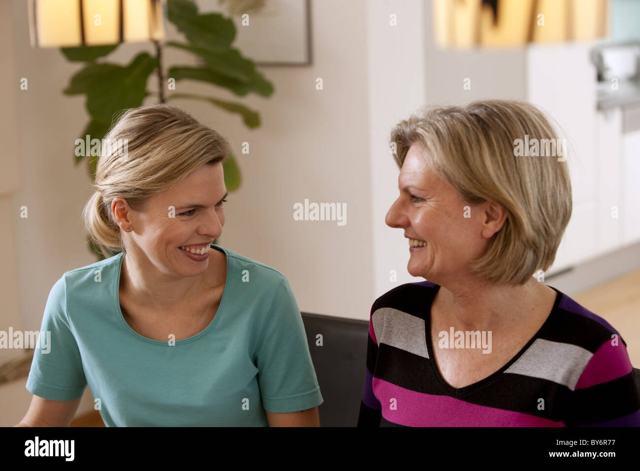 Two women laughing Stock Photo - Alamy