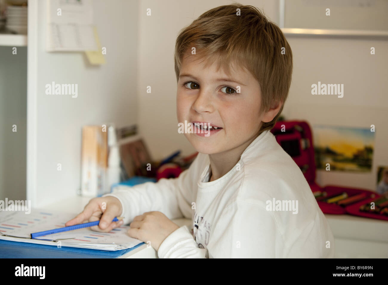 Boy (6 years) doing homework Stock Photo - Alamy