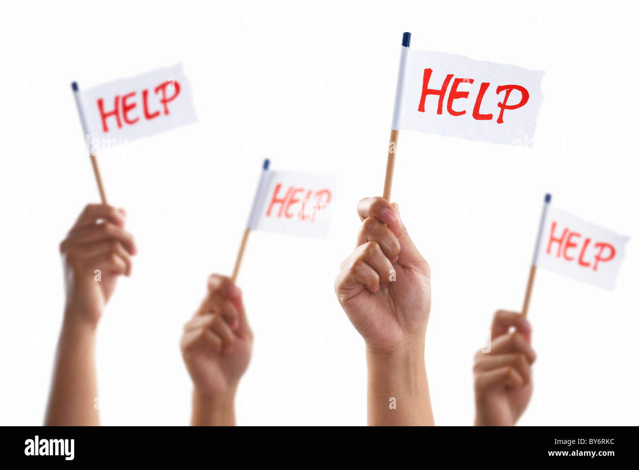 Hands uprising and holding help flag, shot aginst white background ...