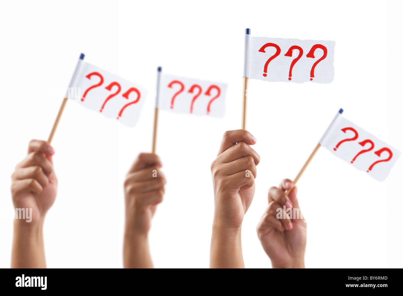 Hands uprising holding question marks flag, shot aginst white ...