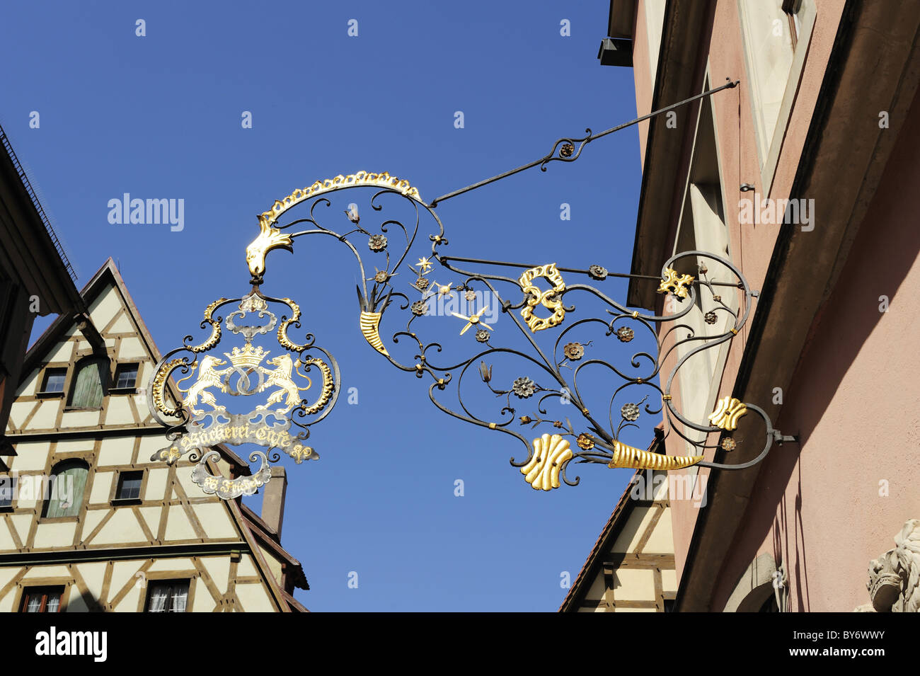 Wrought iron guild sign in front of a half-timbered house, Rothenburg ...