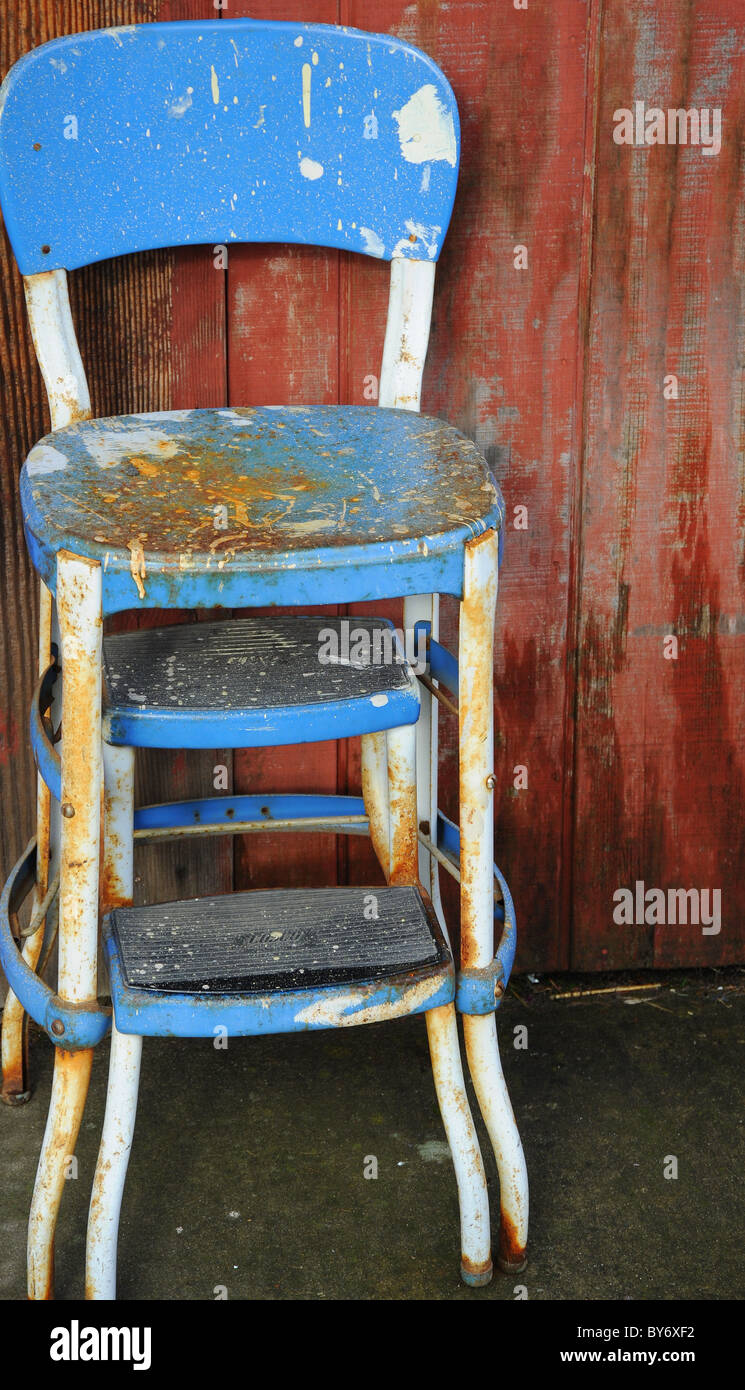 Stacked rusty steel chair and stool Stock Photo - Alamy