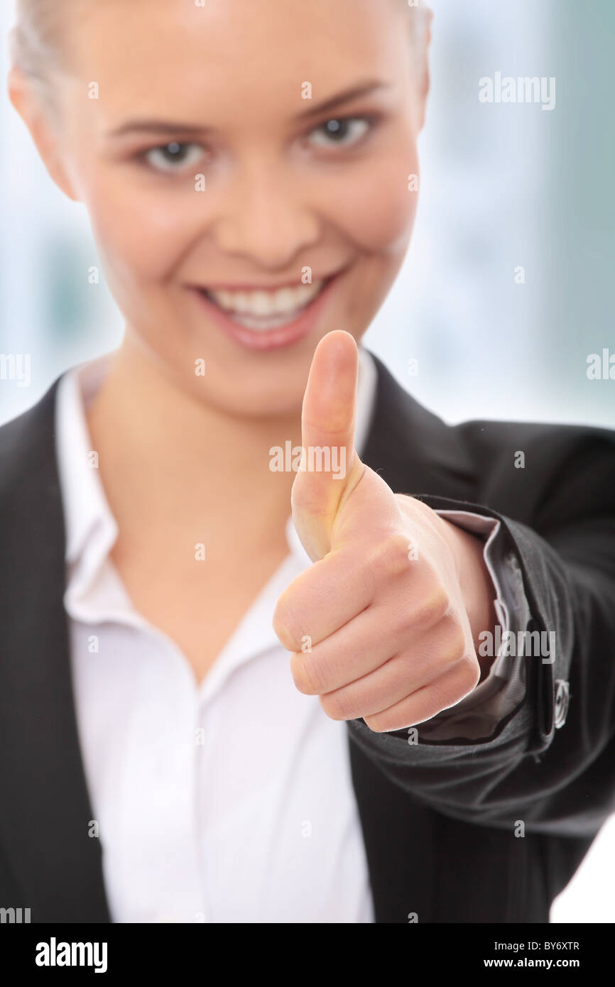 Young business woman showing OK sign, looking at camera and smiling. Focus on hand Stock Photo ...
