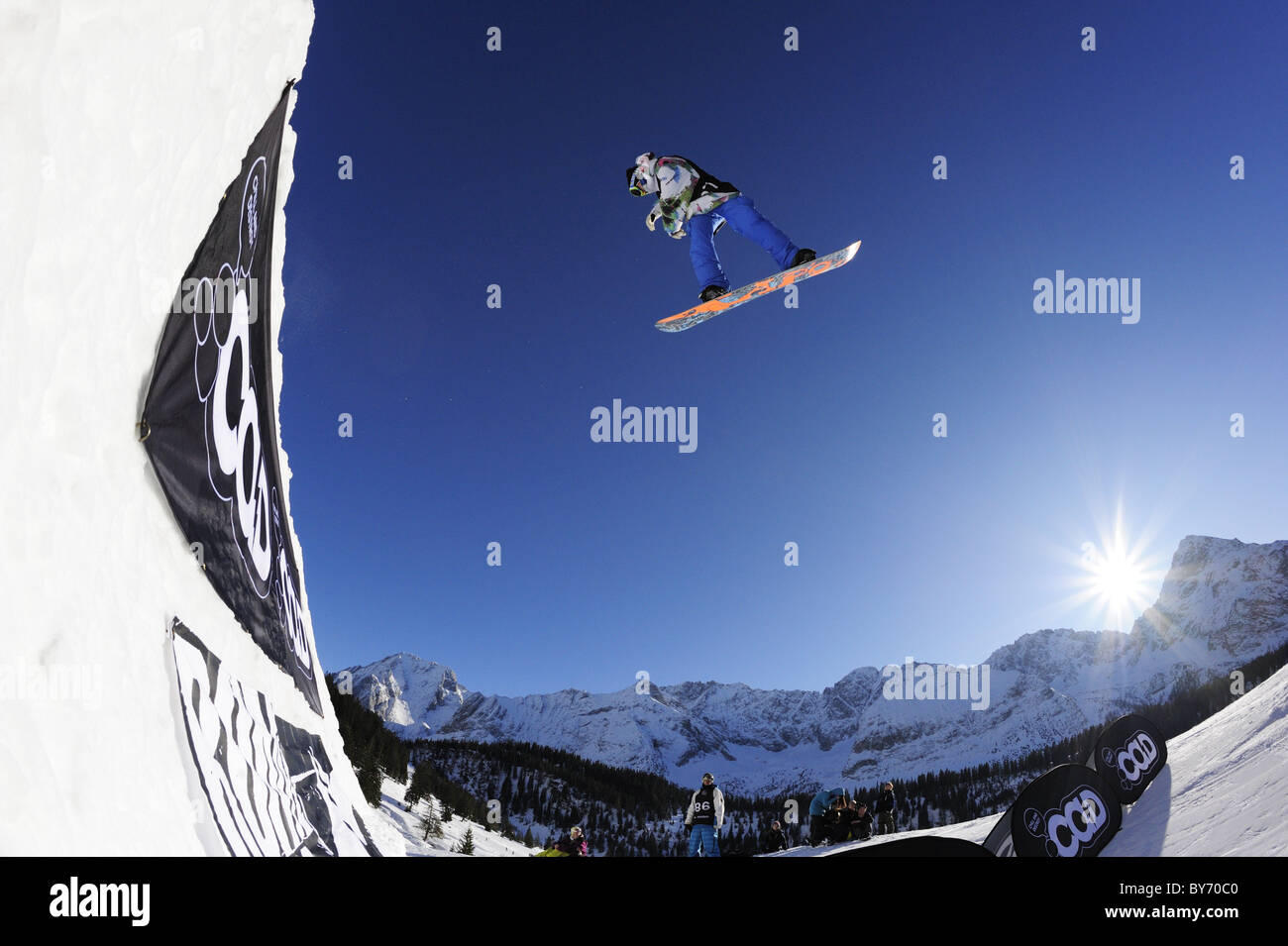Snowboarder jumping from a kicker, performing a stunt, funpark ...