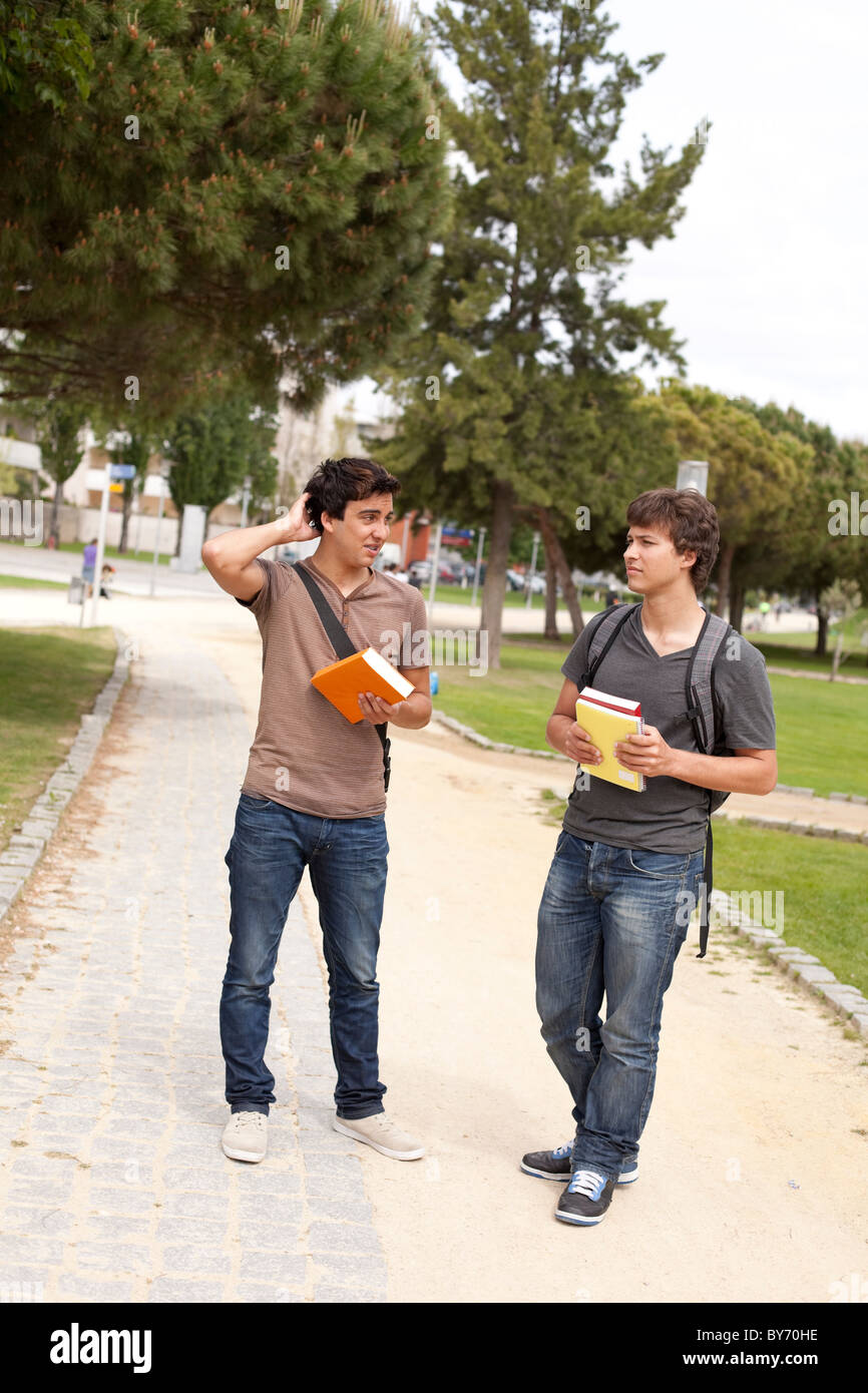 two young student talking at the school park Stock Photo - Alamy