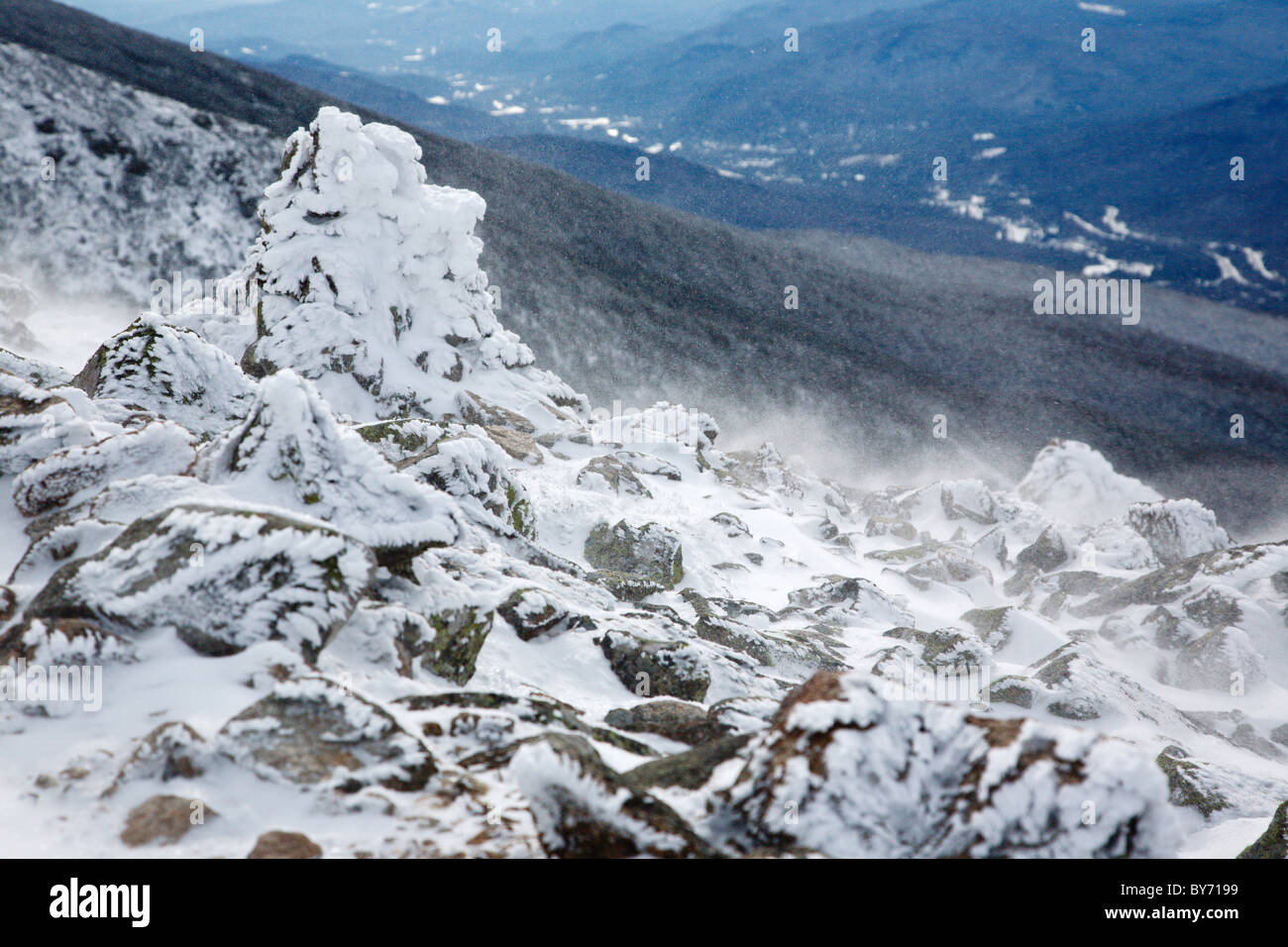 Strong winds blow snow across the open ridge of Mount Lafayette along ...
