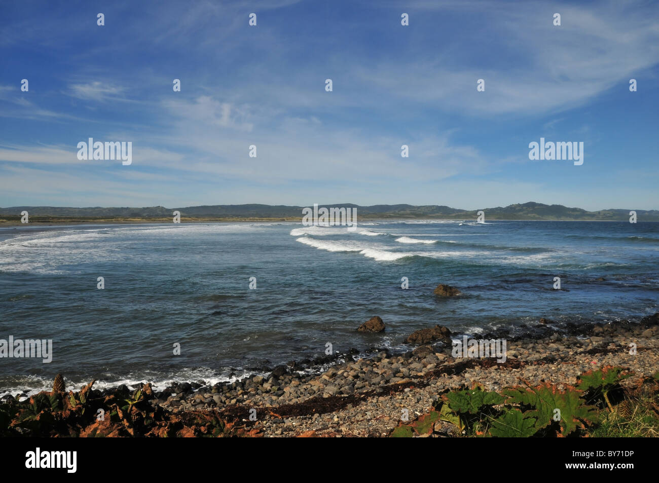 Dark blue waters of Bahia Cocutue, with white surf breakers displaying ...