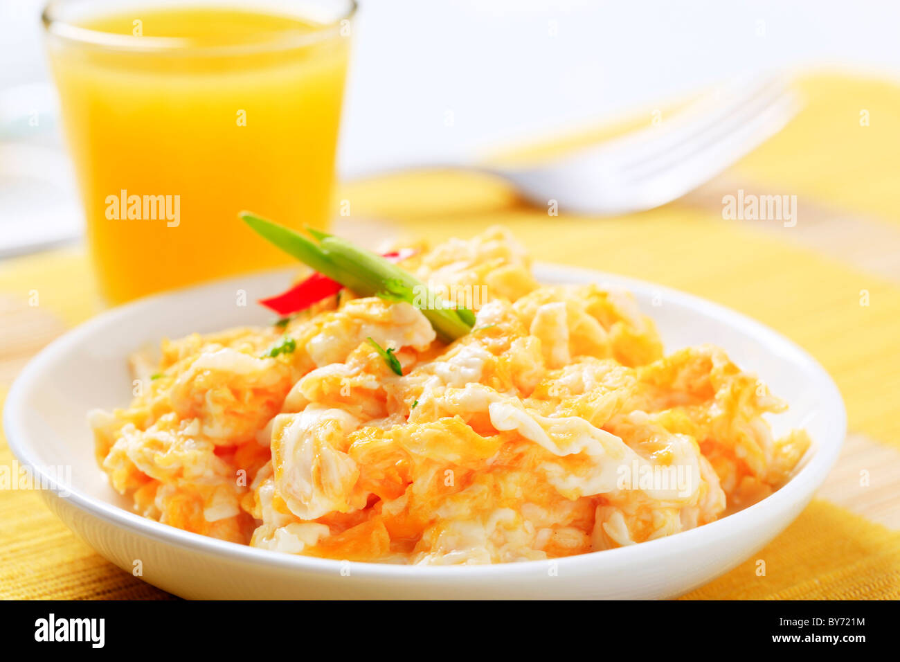 Scrambled eggs and a glass of juice Stock Photo - Alamy