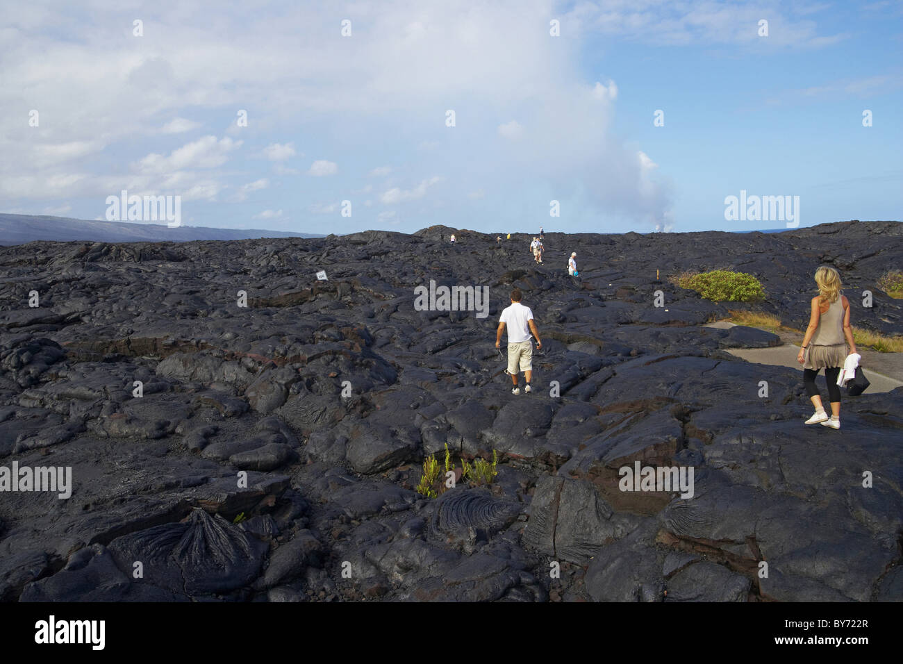 People walking over volcanic rocks, Hawaii Volcanoes National Park ...