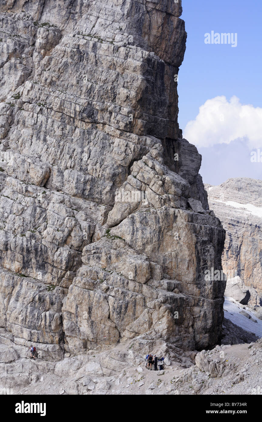 Group of mountaineers standing at the start of a fixed rope route ...