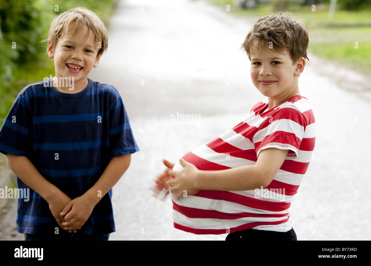 Two boys (6 - 7 years), one boy covering ball with shirt Stock Photo ...