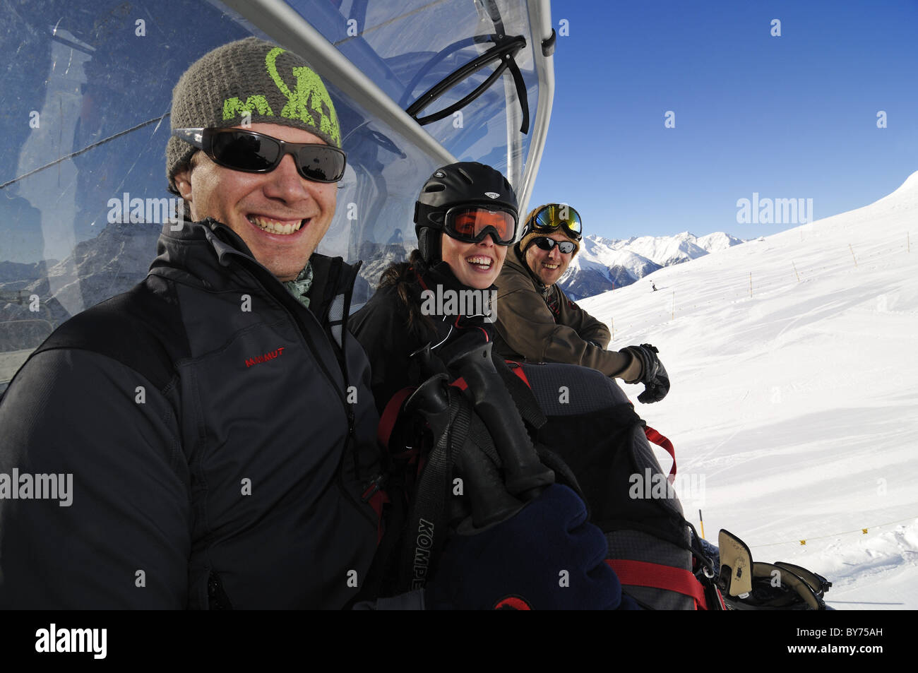 Laughing skiers on chair lift, Champatsch, Engadin, Grisons, Switzerland, Europe Stock Photo - Alamy