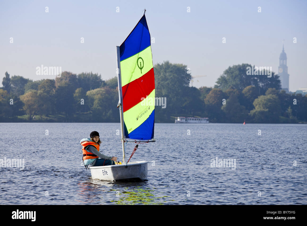 Girl in sailing dinghy Optimist on outer Alster, Hamburg, Germany Stock ...