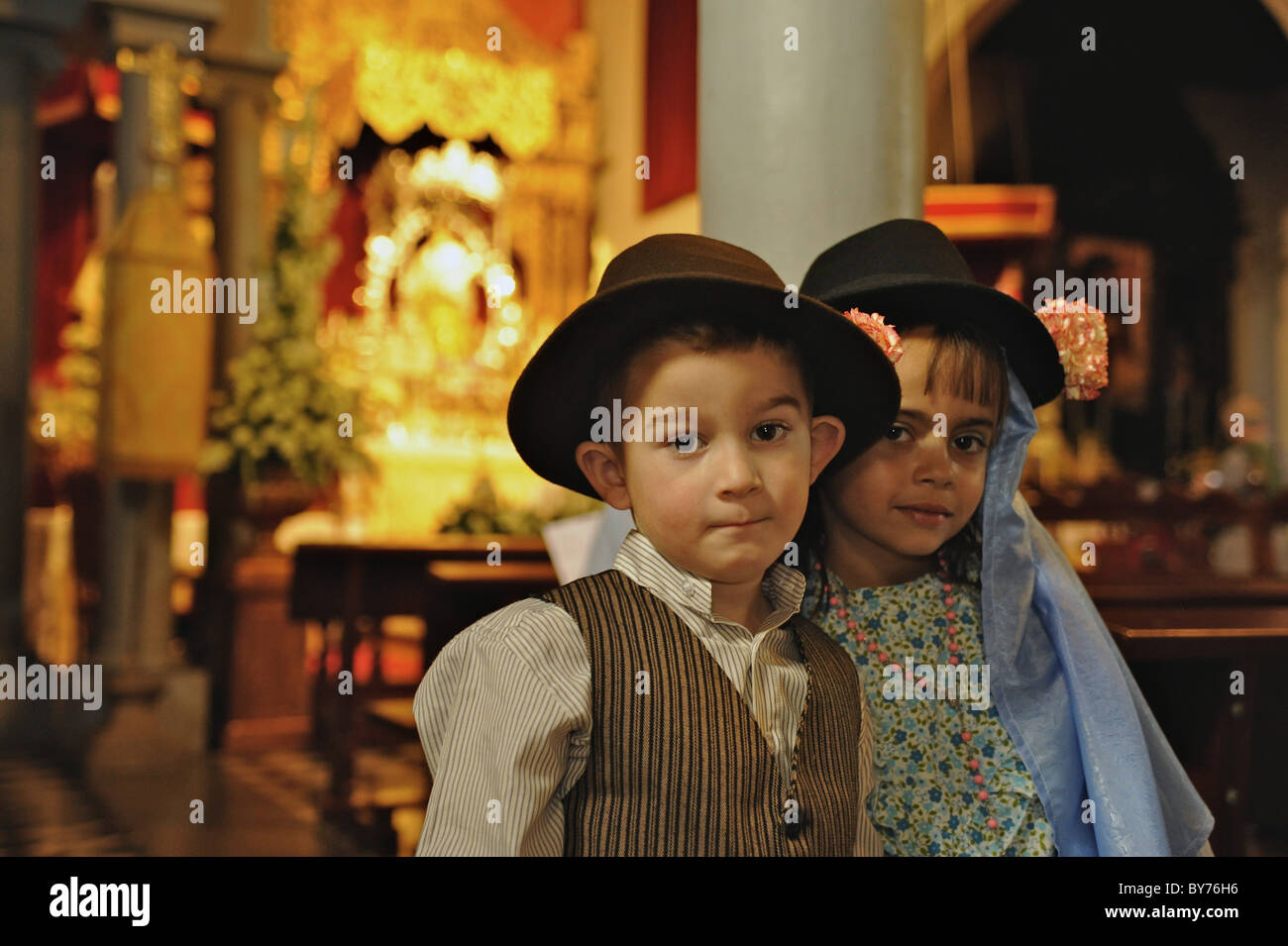 Boy and girl in canrian traditional costumes in the church at Los ...