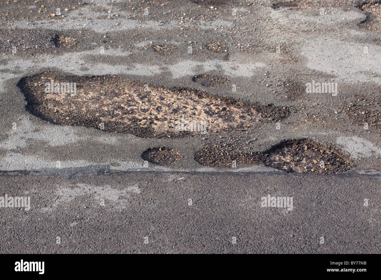 Potholes in the road Stock Photo - Alamy