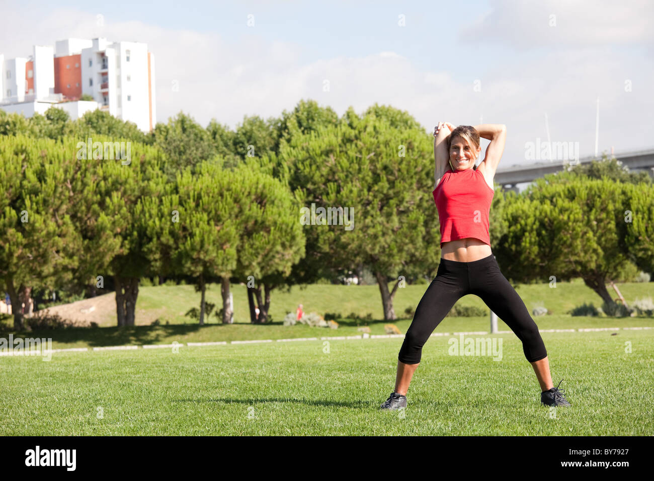 young woman doing some exercise at the park Stock Photo - Alamy