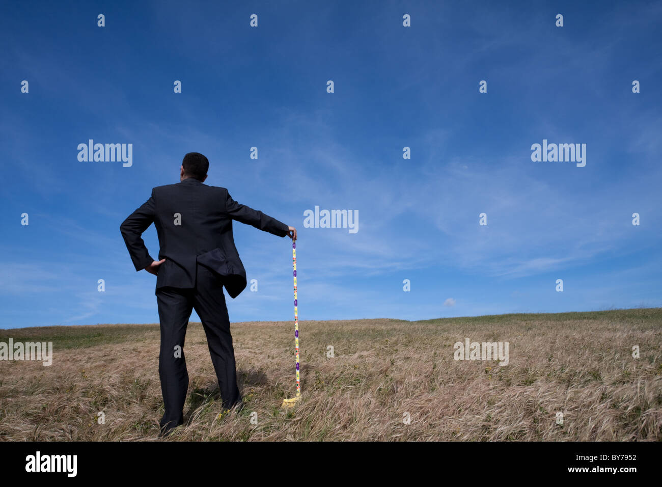 businessman cleaning the field with a broom Stock Photo - Alamy