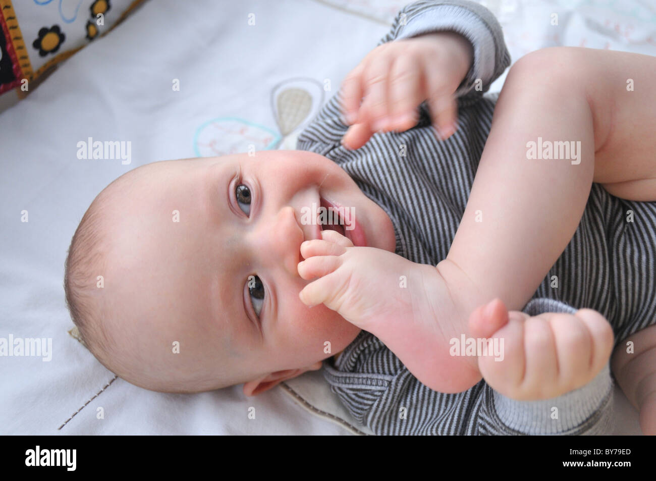 Baby playing with his foot Stock Photo - Alamy