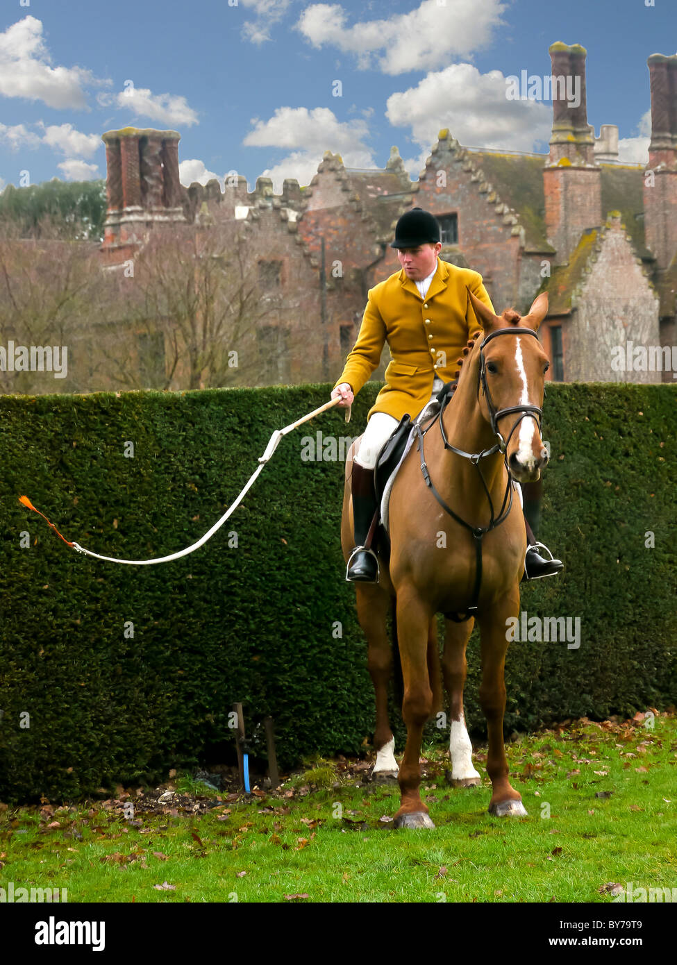 Houndsman in Yellow jacket cracking his whip at the Hunt at Chenies ...