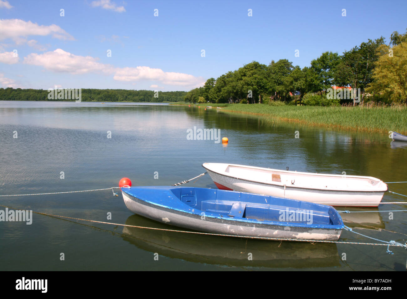Idyllic lake with tiny boats Stock Photo - Alamy