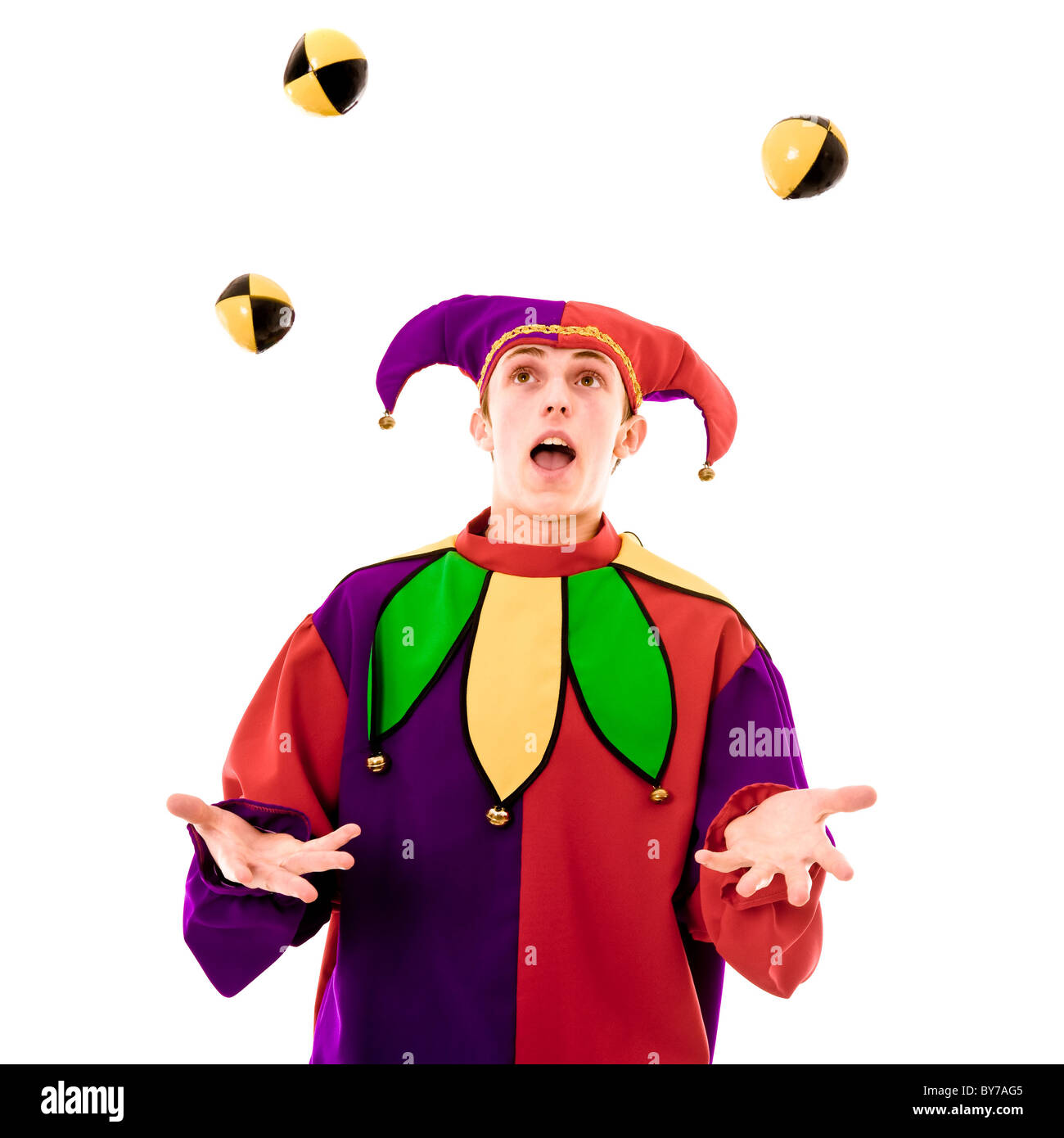 Head and shoulders studio shot of caucasian male Jester with juggling balls. White background ...