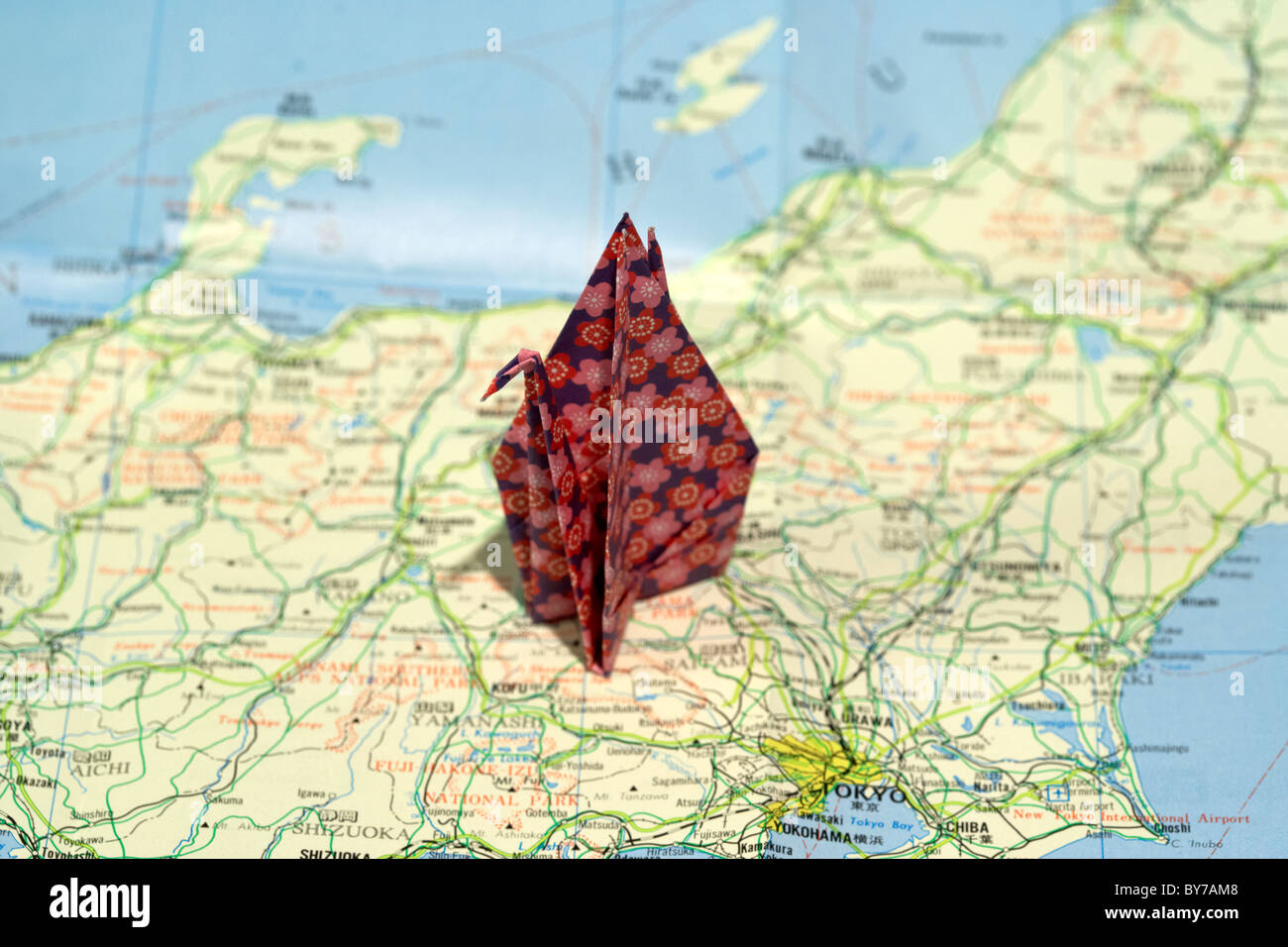 origami swan as prepared in japanese hotels sitting on a tourist map of ...