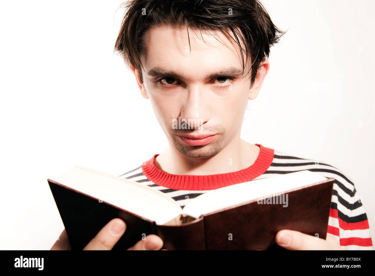 serious young man reading a book on a white background Stock Photo - Alamy