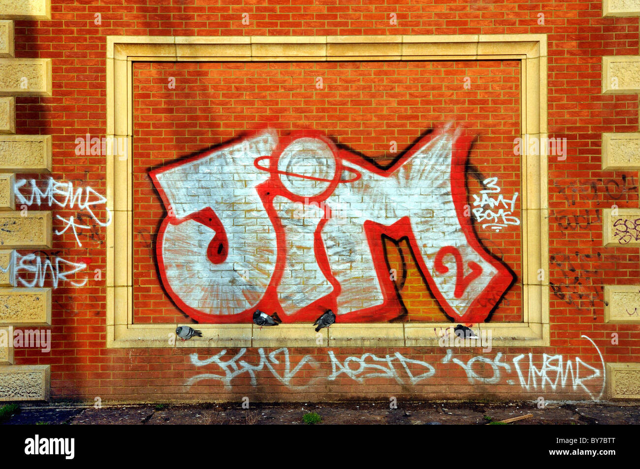 Graffiti on brickwork with the word 'Jim' in silver paint Stock Photo ...