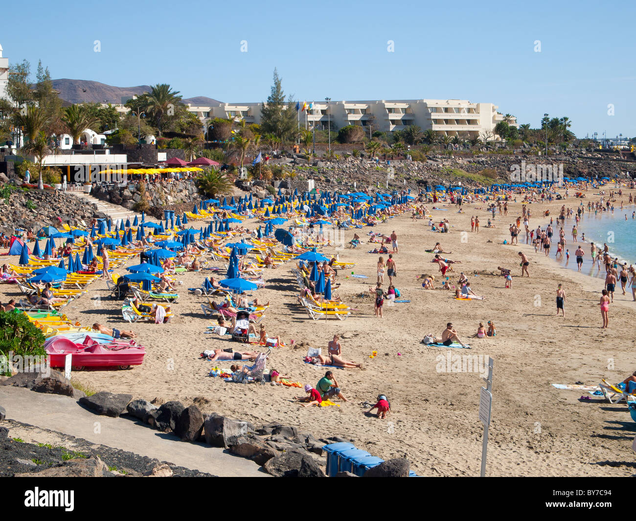 Busy Playa Dorada beach in Playa Blanca Lanzarote on a hot day in early ...