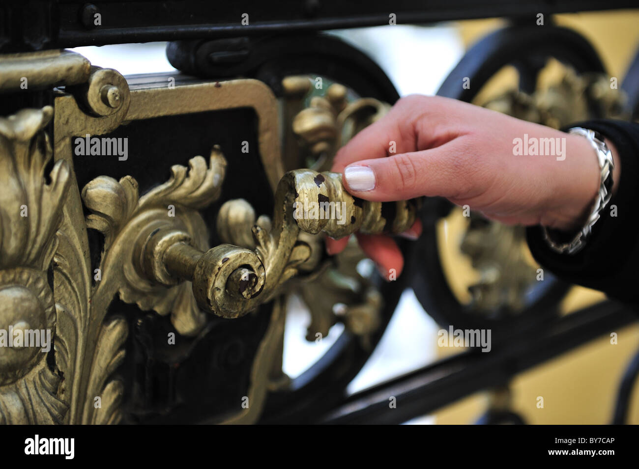 Hand opening a gate Stock Photo - Alamy