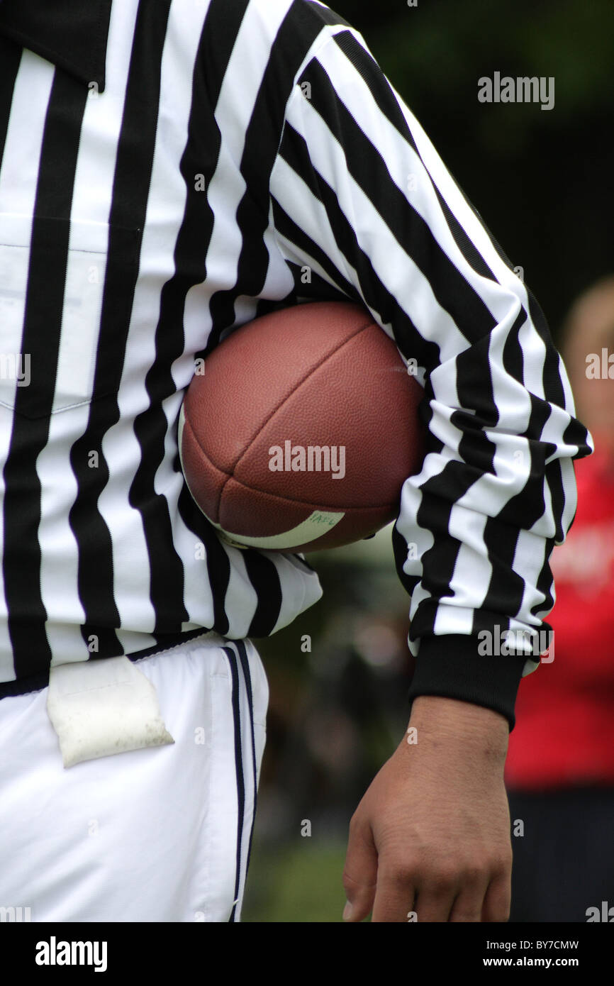 Referee holding a football Stock Photo - Alamy