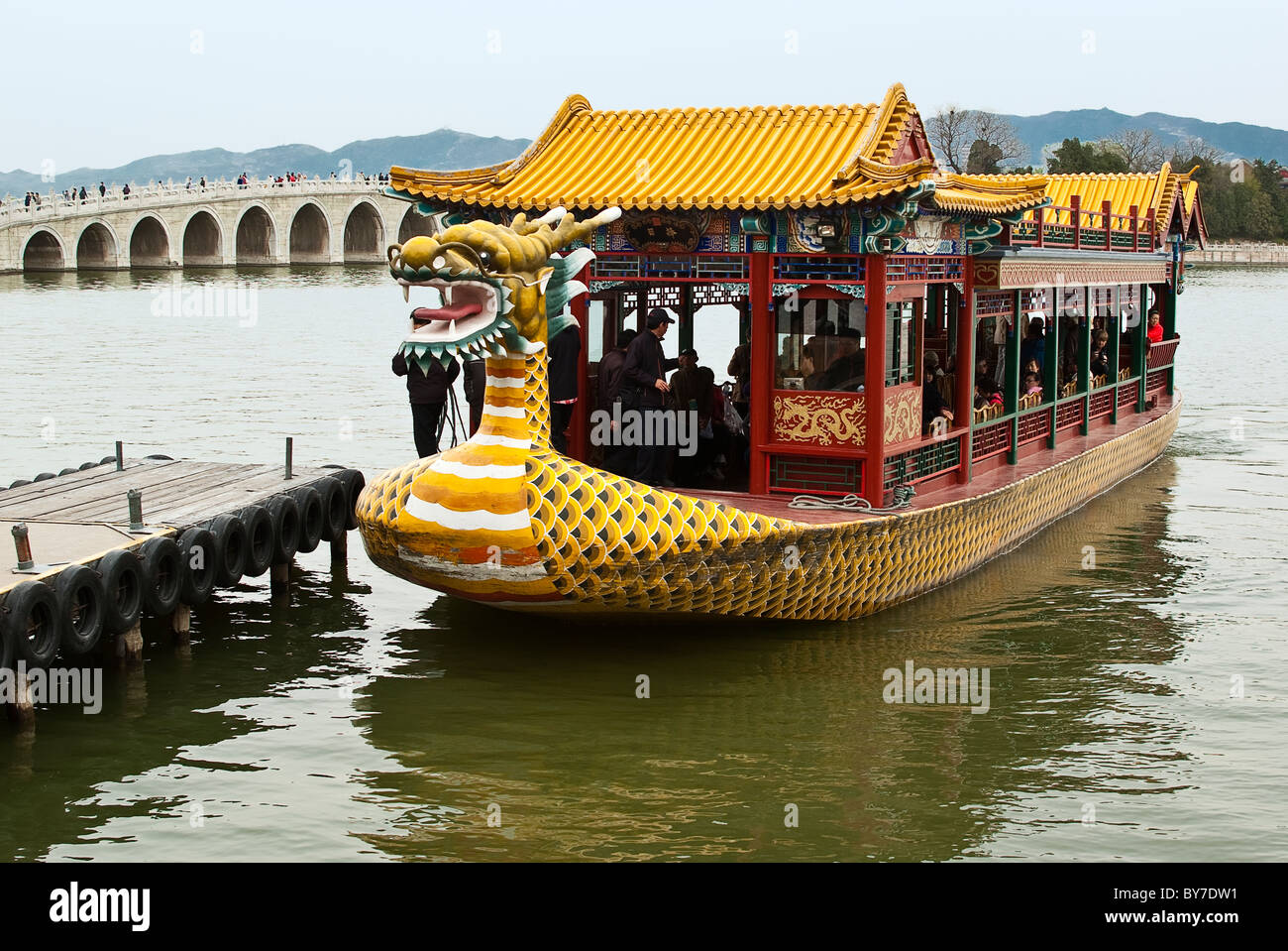 Asia, China, Beijing. Dragon boat ferries people across Kunming Lake at ...