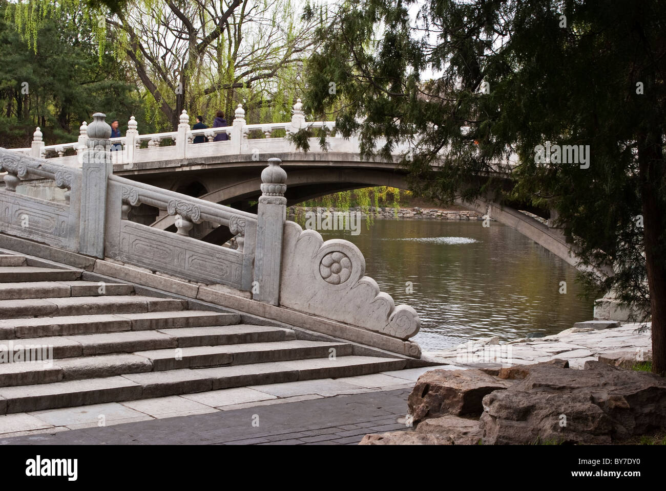Asia, China, Beijing. Two marble stone arch bridges at the Summer ...