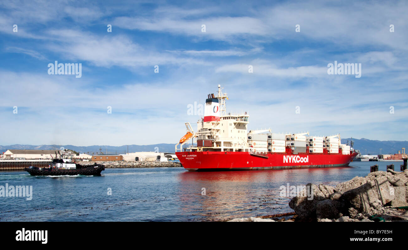 Container ship and tugboat in a harbor Stock Photo - Alamy