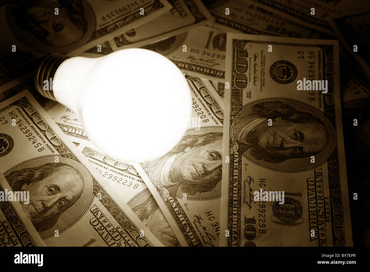 Bright Light Bulb and Dollar close up shot Stock Photo - Alamy