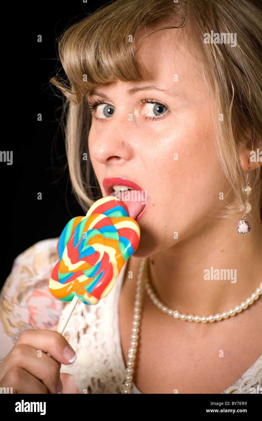 Women licking lollipop hi-res stock photography and images - Alamy