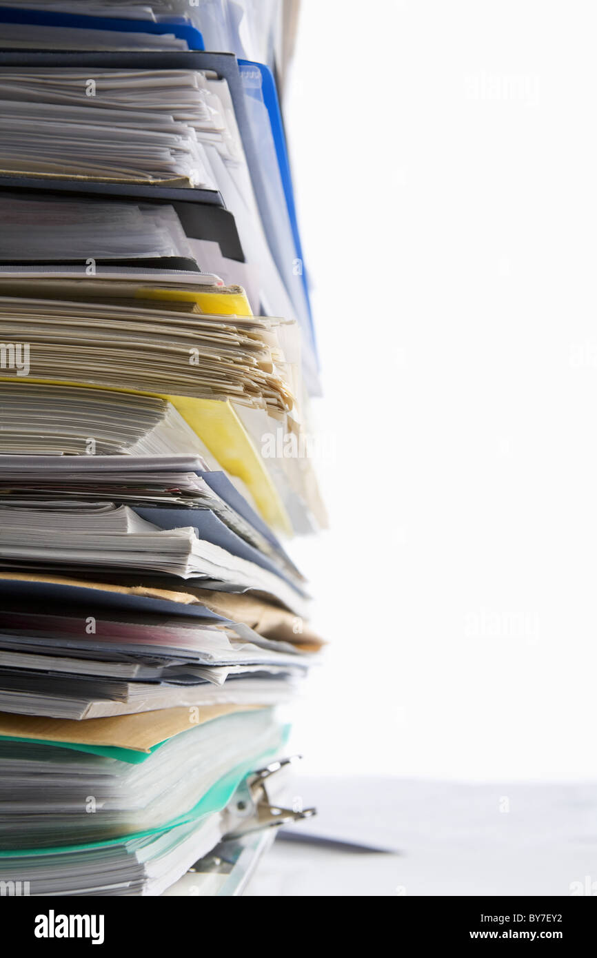 Pile of paperwork shot against white background Stock Photo - Alamy