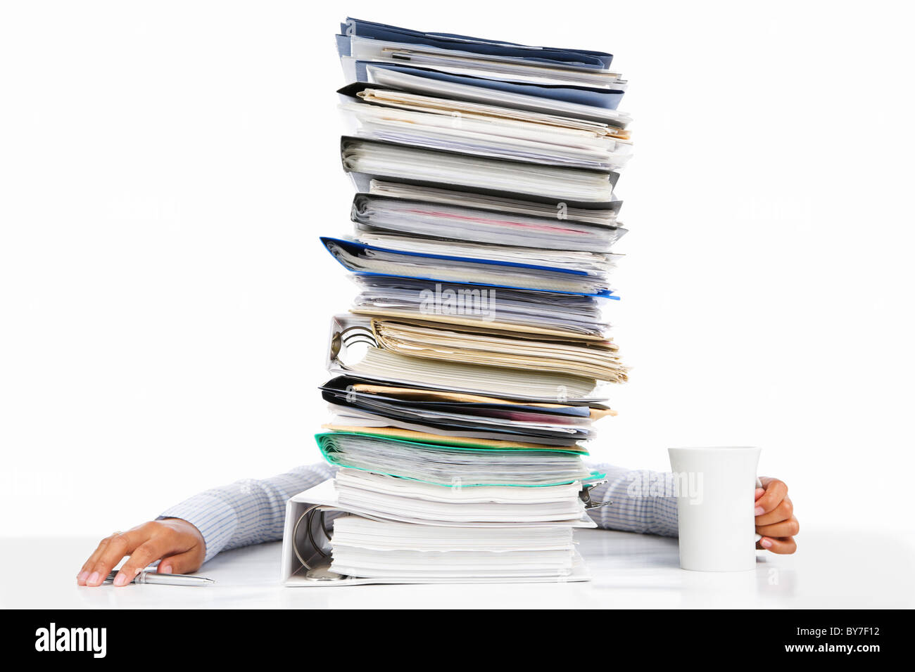 Sleeping worker behing high pile of paperwork, isolated in white ...