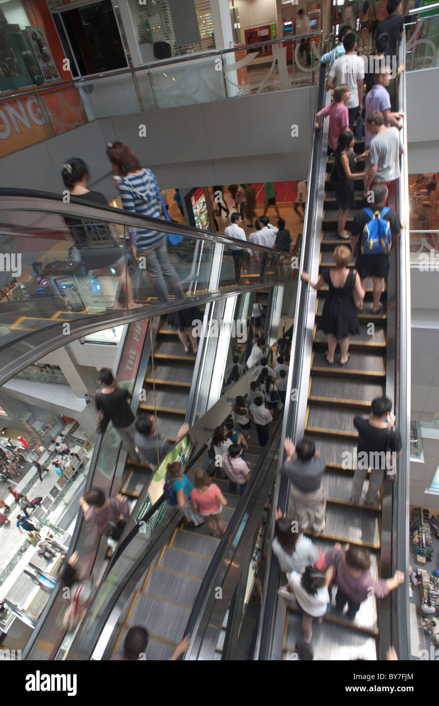 People on escalators at a busy shopping mall Stock Photo - Alamy