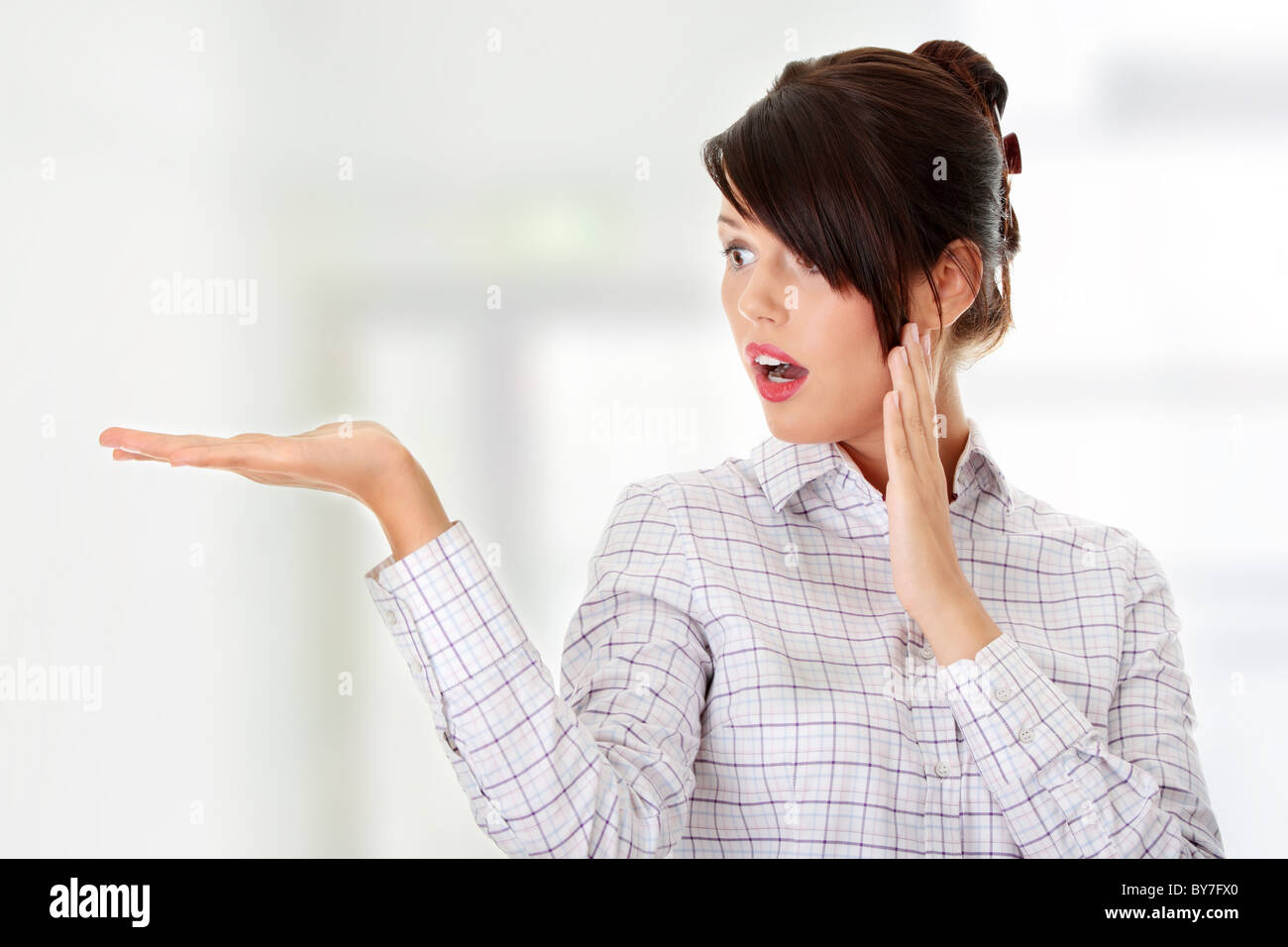 Young happy businesswoman presenting something on her hand Stock Photo ...