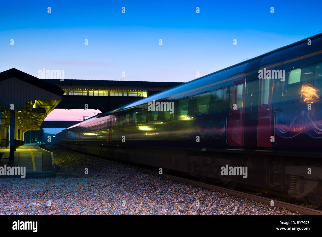 Twilight at the station - Evening train Stock Photo - Alamy