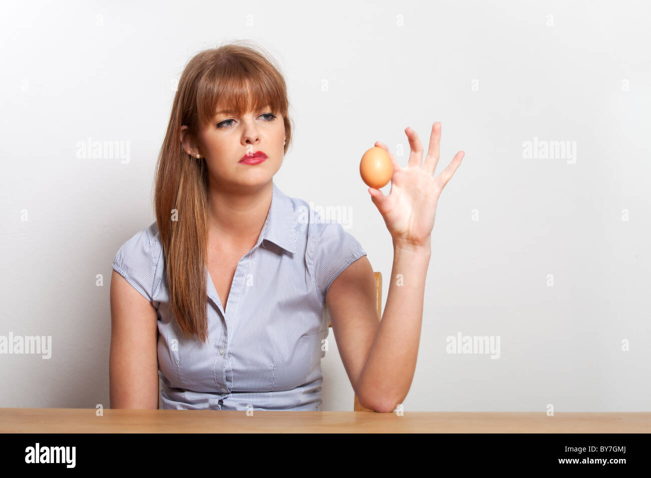 sitting woman and a egg Stock Photo - Alamy