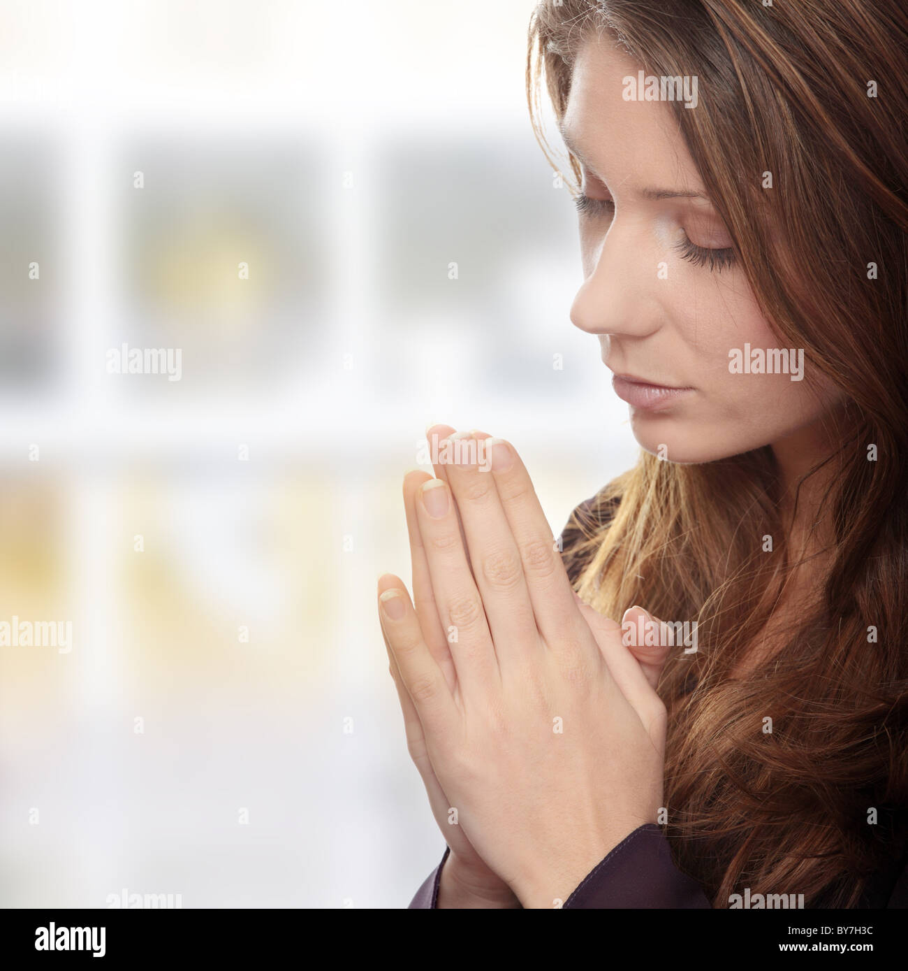 Closeup portrait of a young caucasian woman praying Stock Photo - Alamy