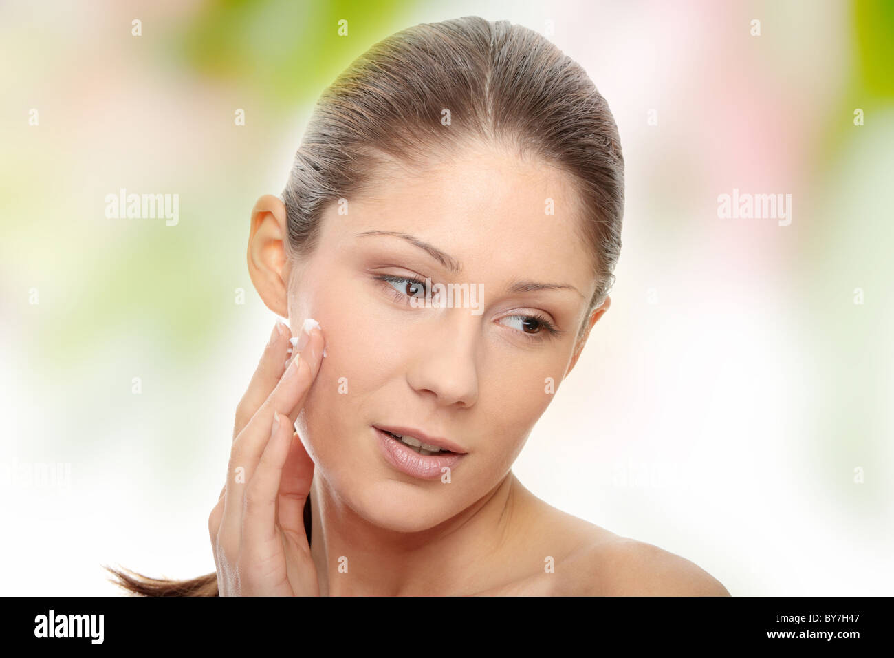 Beautiful young woman with cream. Isolated on white background Stock ...