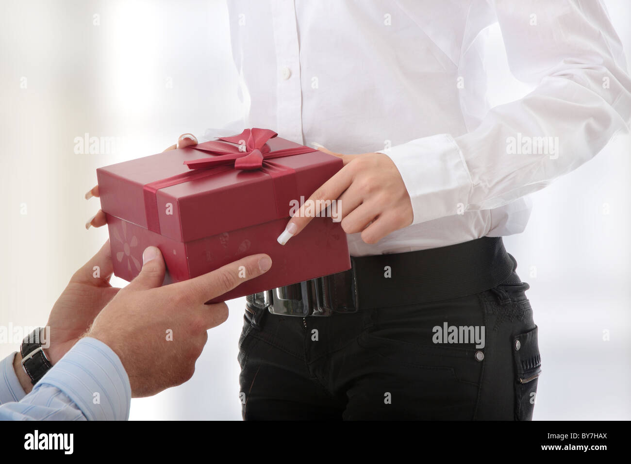 Business man offering a gift to a woman Stock Photo - Alamy