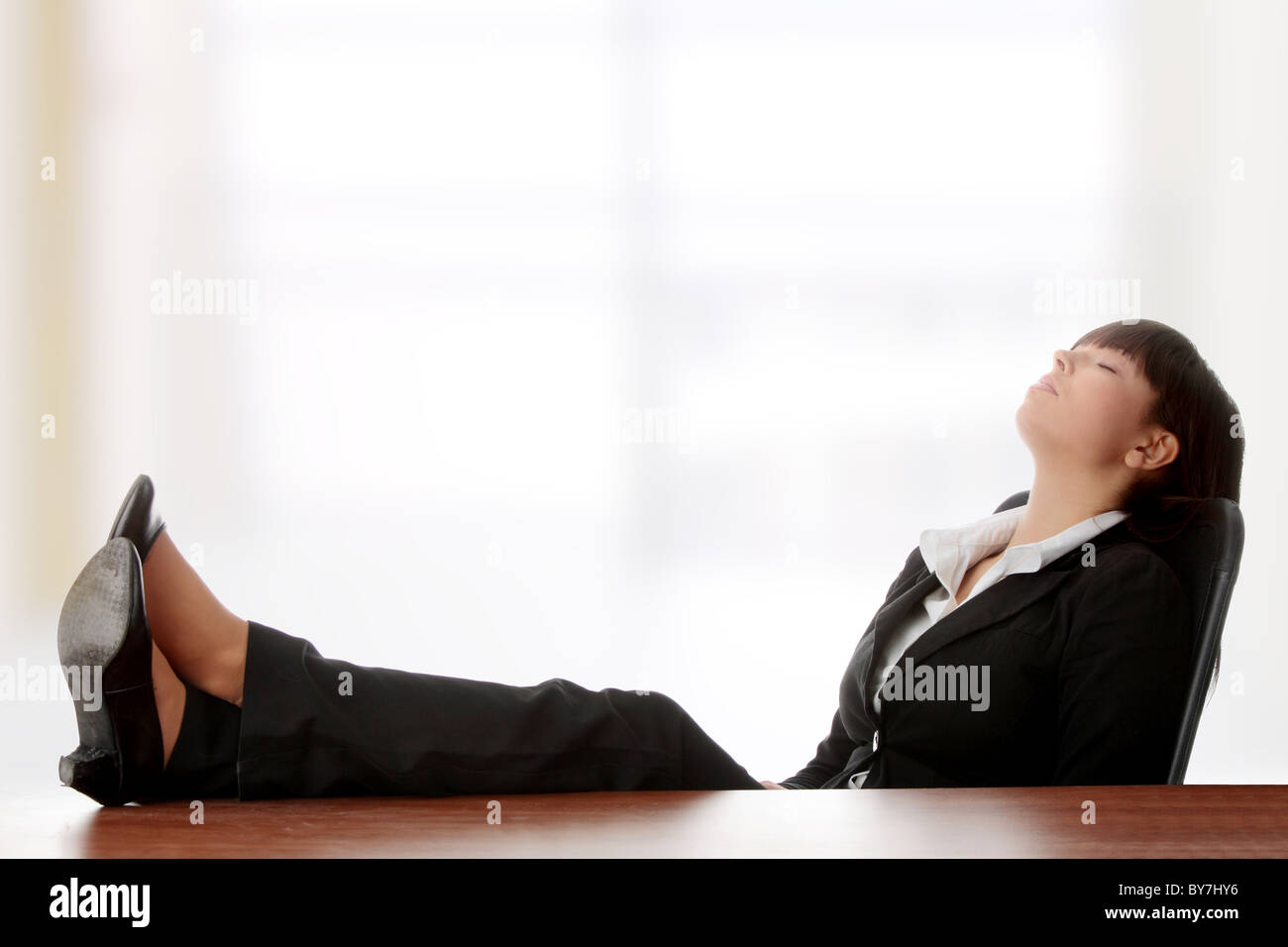 Young beautiful business lady having a rest at the working place Stock ...