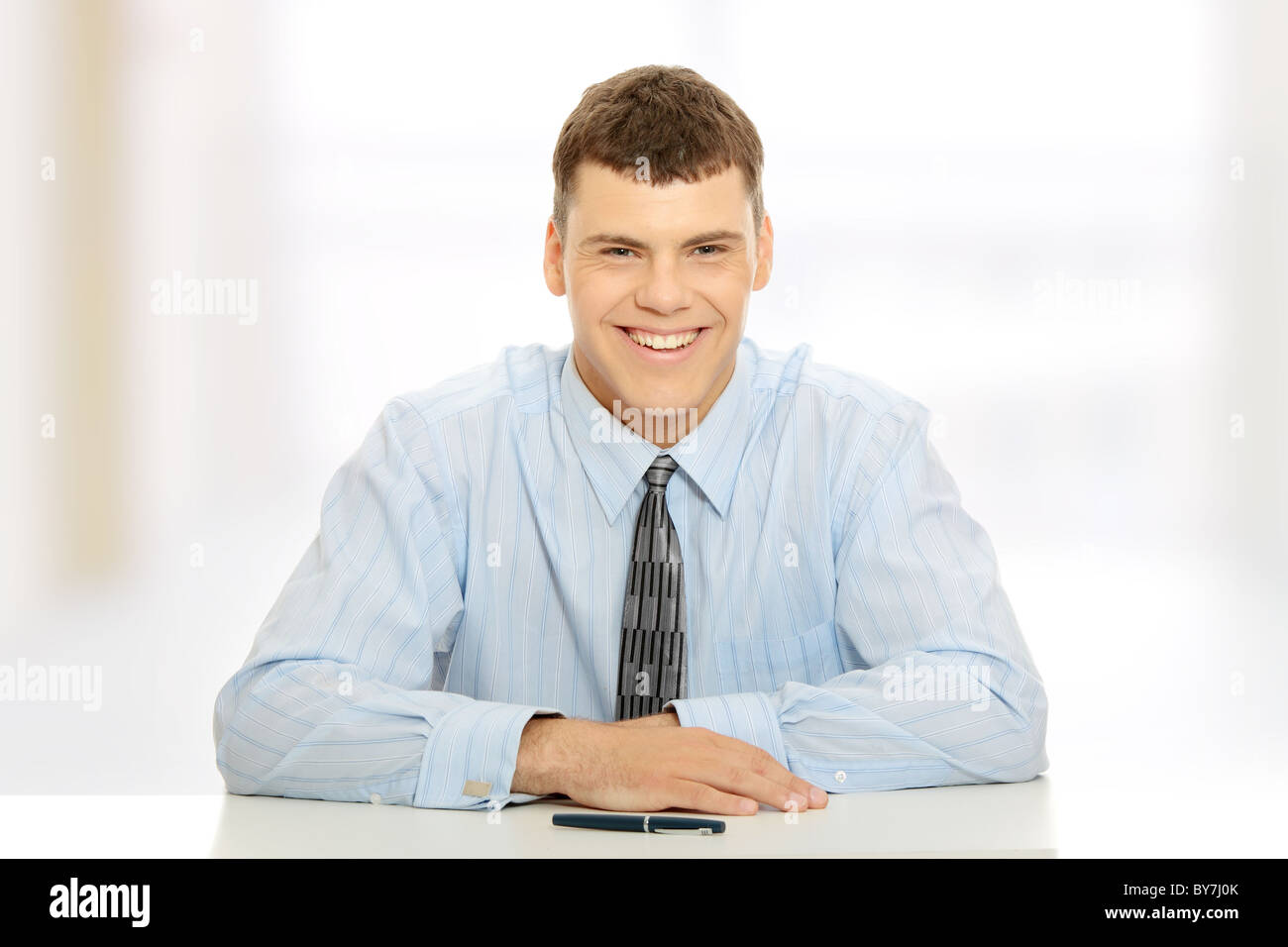 Young businessman behind the desk Stock Photo - Alamy