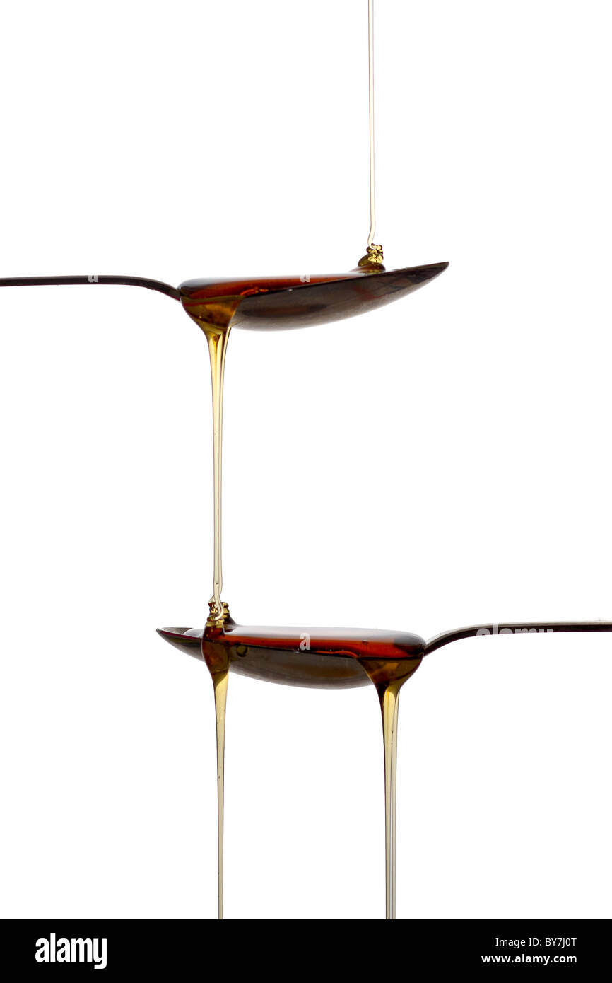 Inviting spoonfuls of syrup being poured out Stock Photo - Alamy